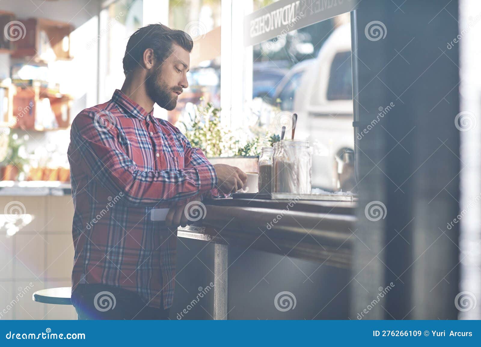 Dont Be Afraid To Take Another Sip...a Young Man Having a Cup of Coffee ...