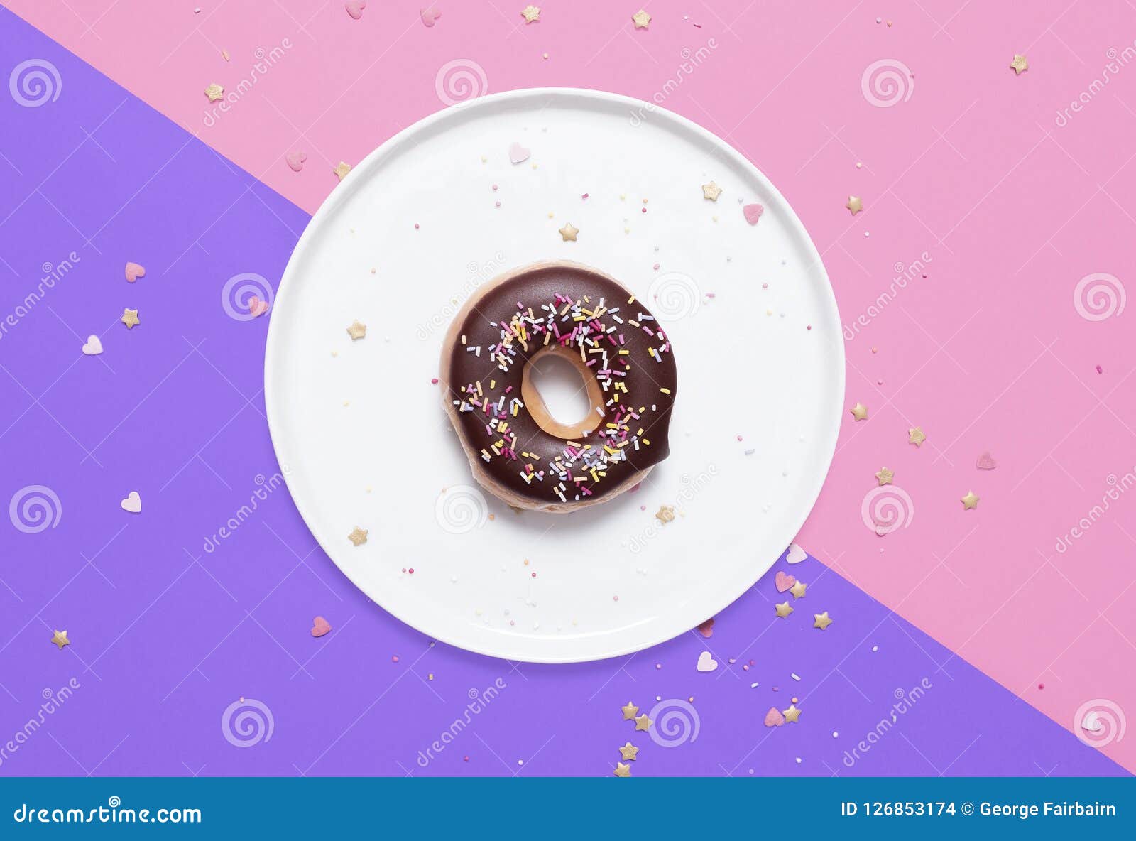Donut on White Plate on a Split Colored Background Stock Photo - Image ...