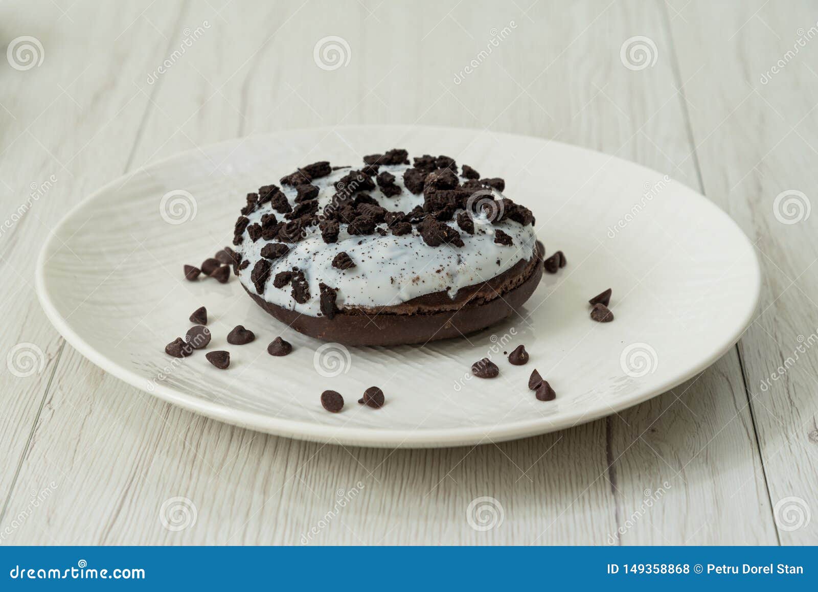 Donut in a Plate on White Wood Background, Close-up Stock Photo - Image ...