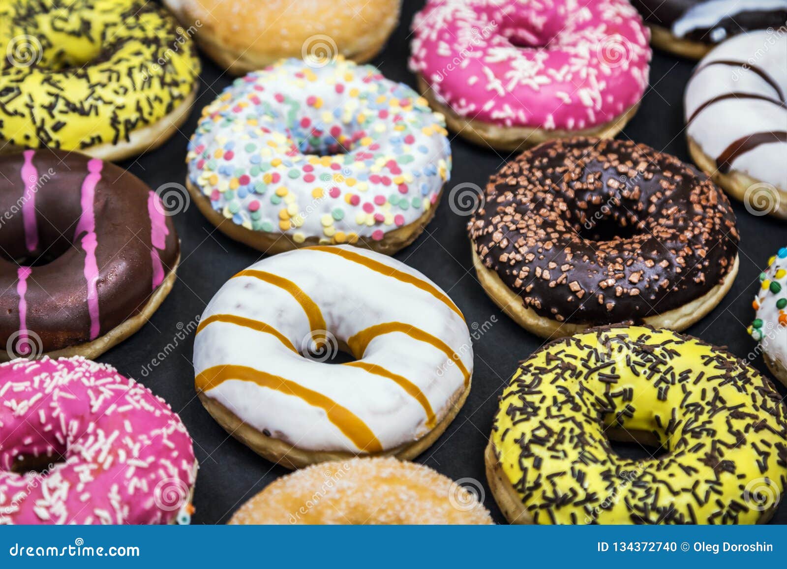Donuts Covered with Icing, Chocolate, Nuts with Different Stock Photo ...