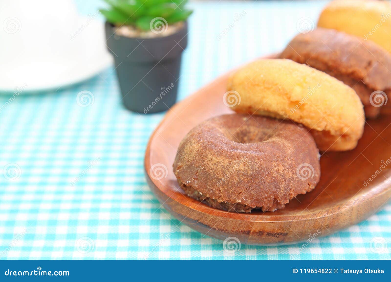 Donuts on a wooden plate stock photo. Image of doughnut - 119654822