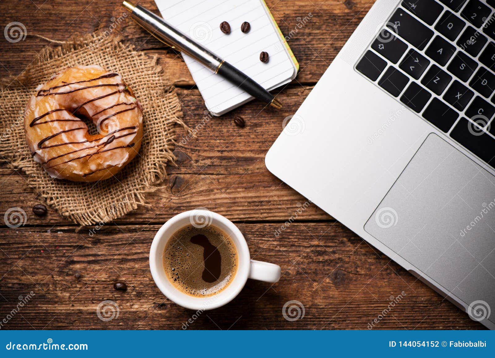 Donuts on working desk stock photo. Image of laptop - 144054152