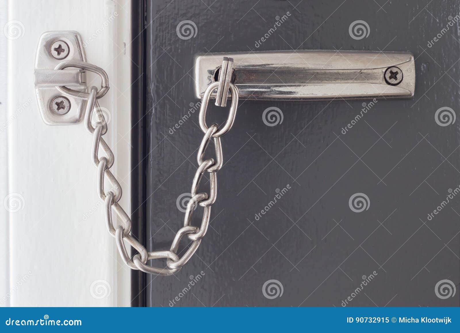 Door chain on a grey door stock image. Image of closeup - 90732915
