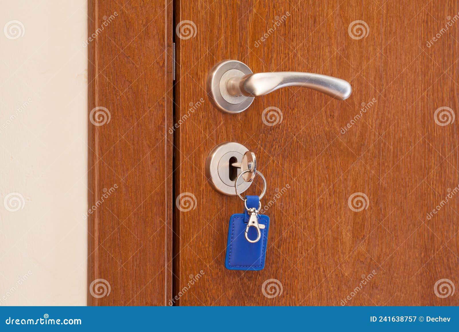 Door Handle with Inserted Key in the Keyhole with Blue Keyholder Stock ...