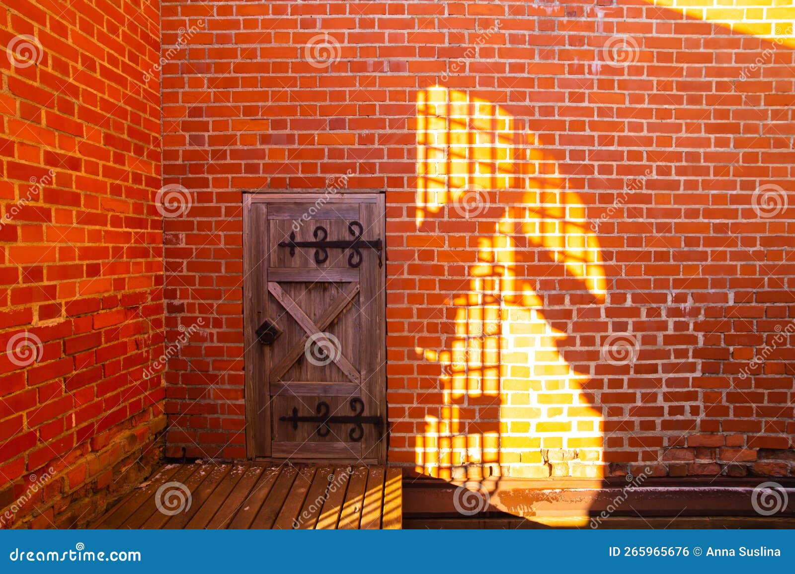 A Door and Part of Brick Wall with Shadows Inside a Castle Stock Photo ...