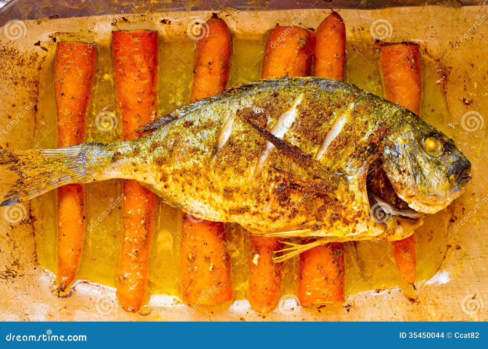 Dorade with Curry on Carrots in Oriental Style Stock Photo - Image of ...