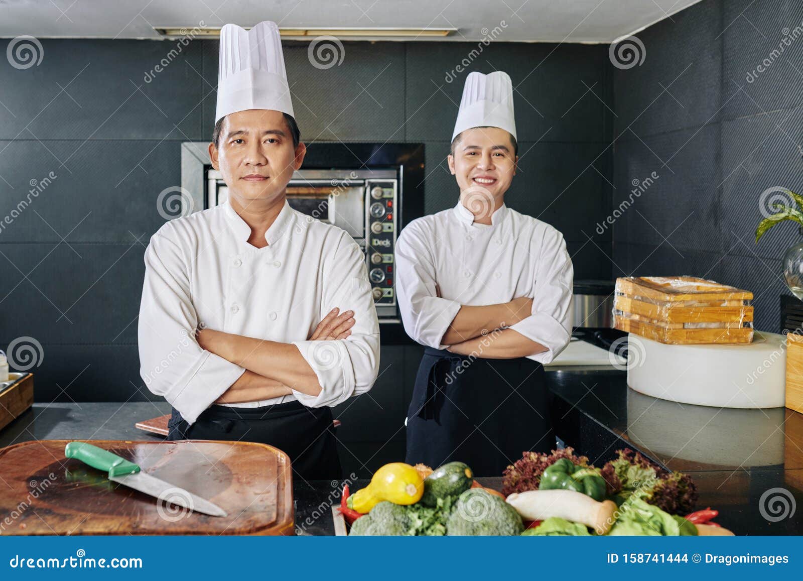Dos chefs en la cocina foto de archivo. Imagen de sonriente - 158741444