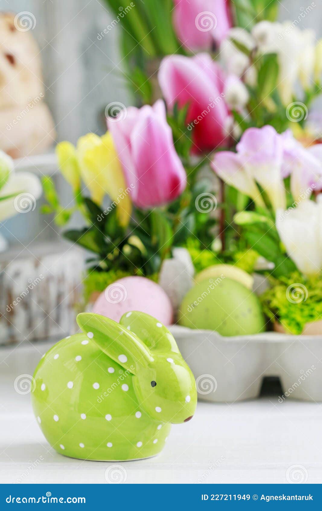 Dotted Green Ceramic Rabbit and Floral Decoration in the Background ...