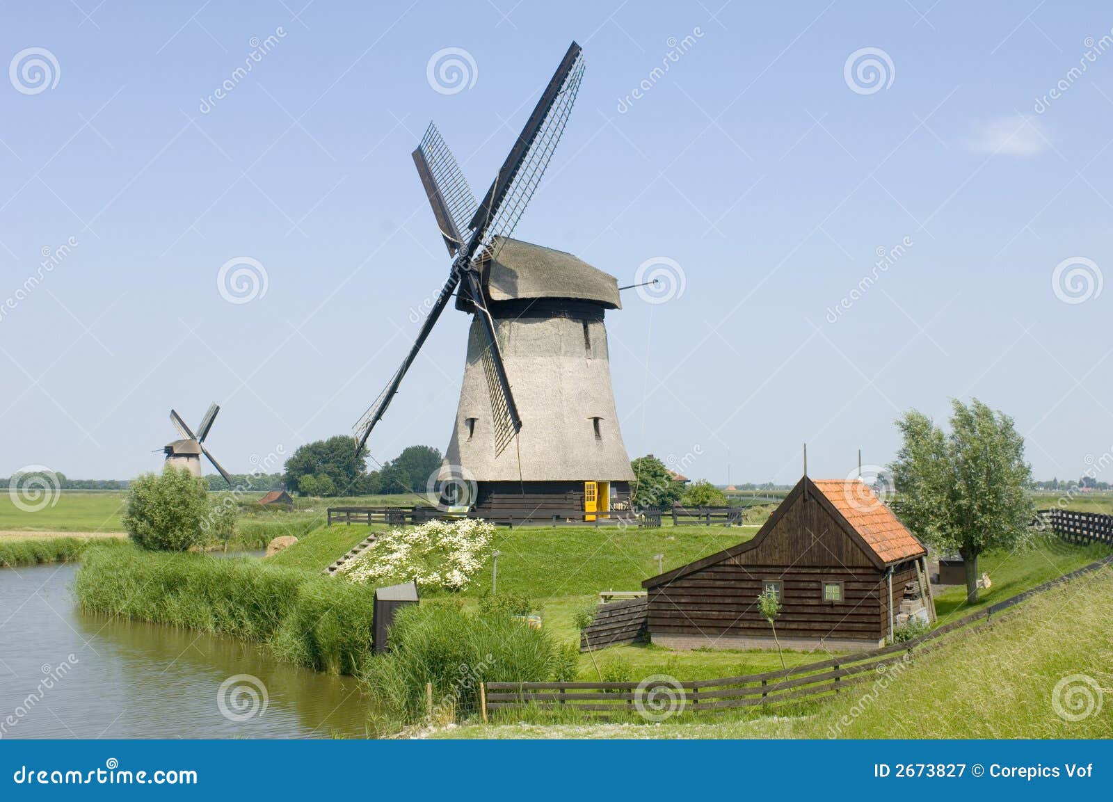 Double Dutch windmills stock image. Image of grass, water - 2673827