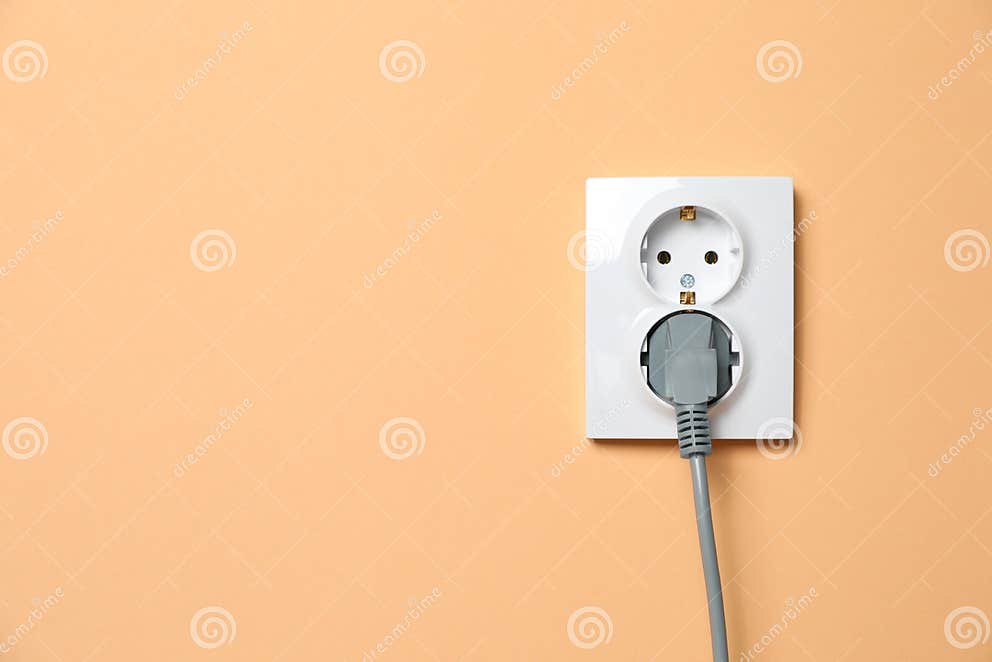 Double Power Socket with Inserted Plug on Pale Orange Wall, Space for ...