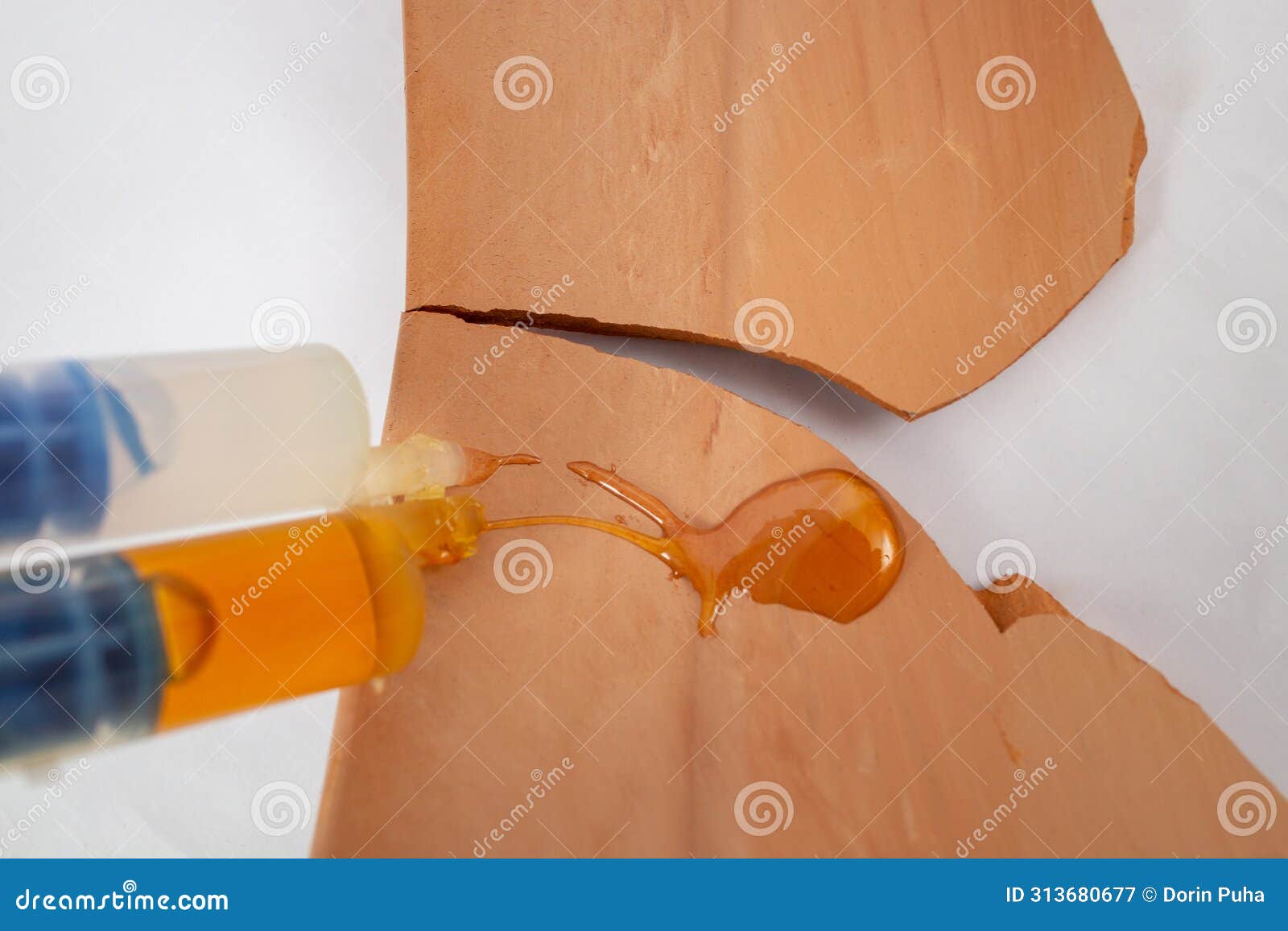 Double Syringe with Epoxy Gel Gluing and Spilling on Broken Brown ...