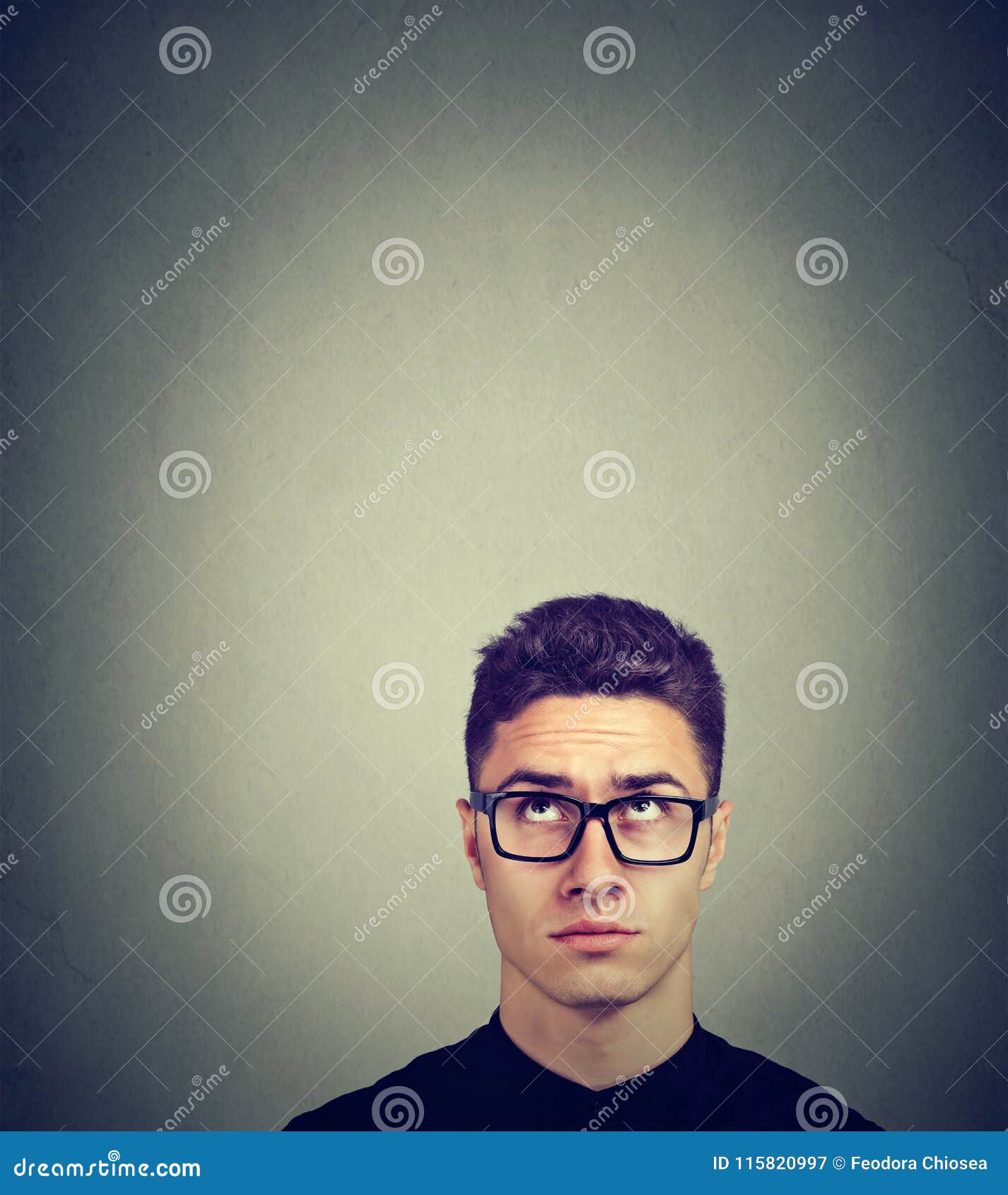 Doubtful Young Man in Glasses Looking Up Stock Image - Image of ...