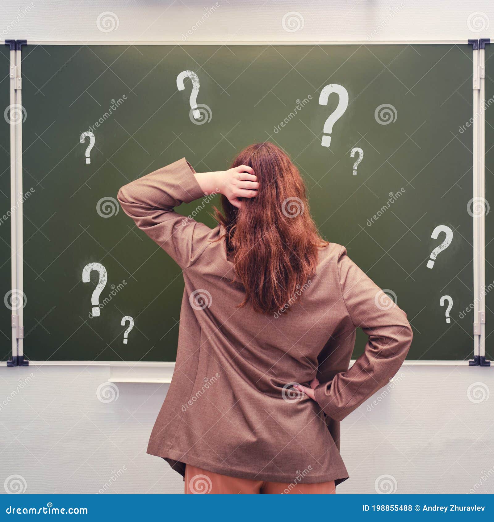Doubting Teacher Stands at the Blackboard with Question Marks Stock ...