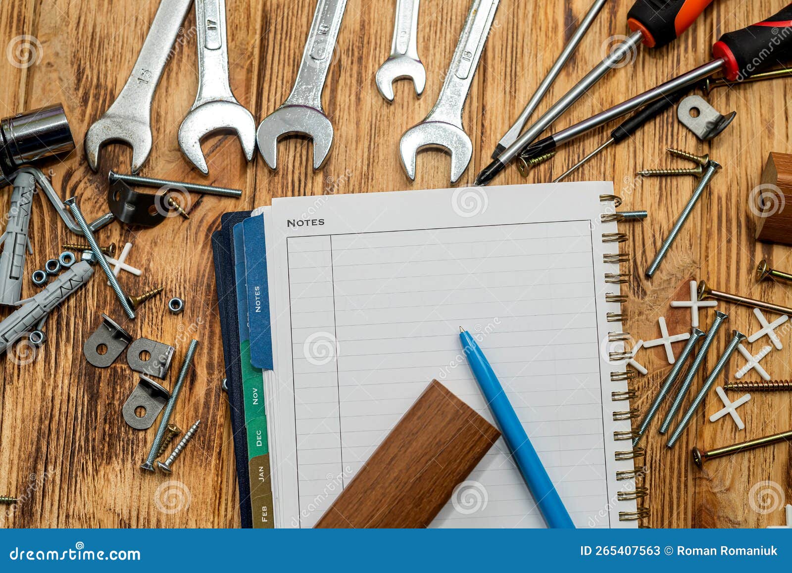 Dowel Screws and Keys are Scattered on the Table Next To a Folder and a ...