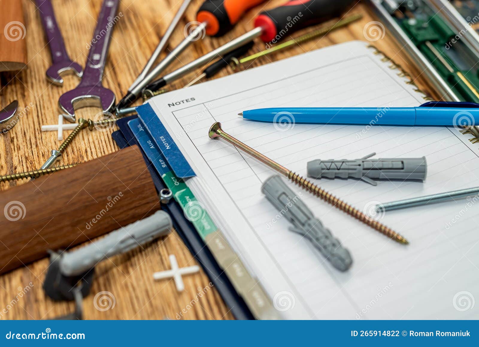 Dowel Screws and Keys are Scattered on the Table Next To a Folder and a ...