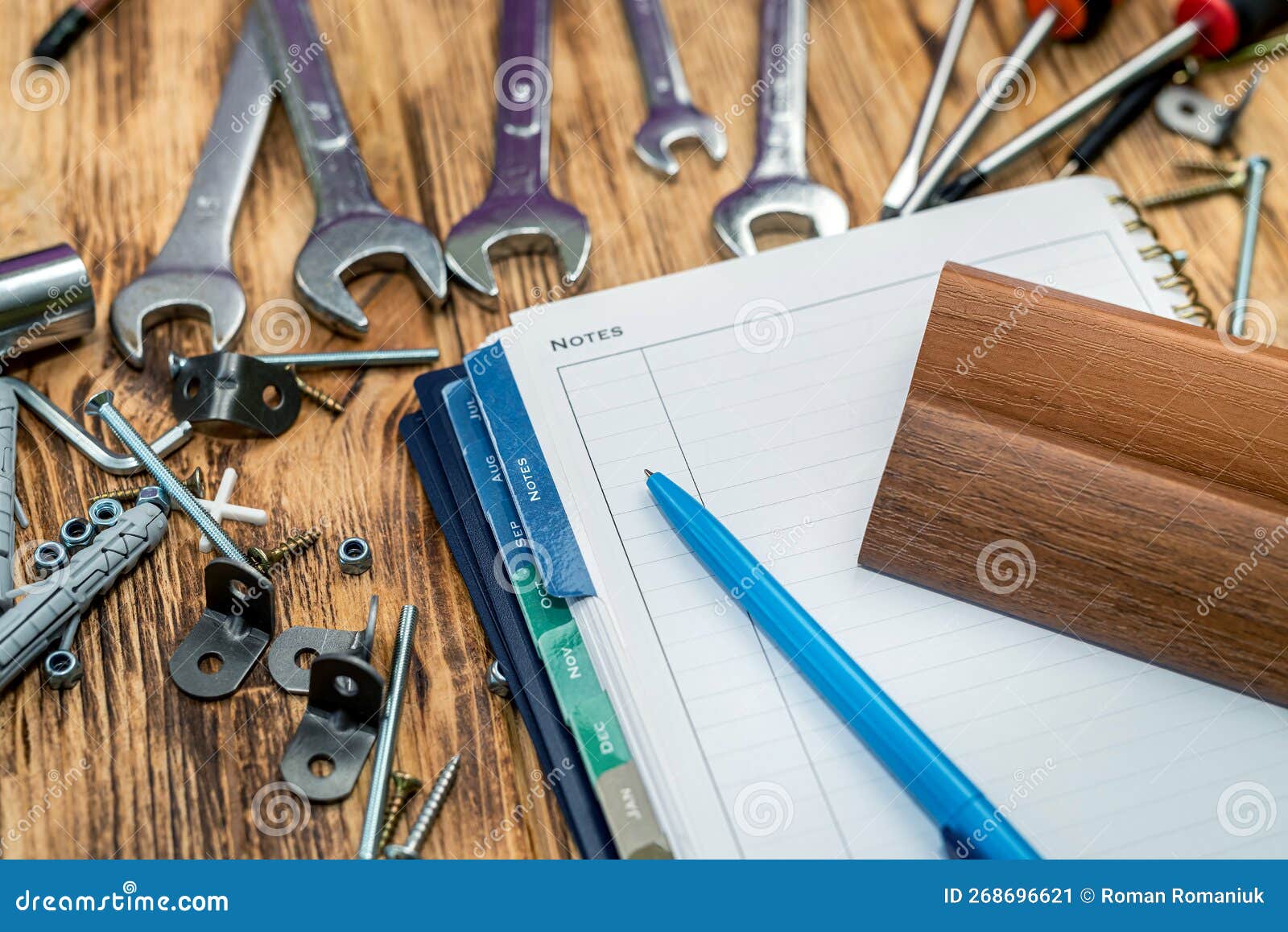 Dowel Screws and Keys are Scattered on the Table Next To a Folder and a ...