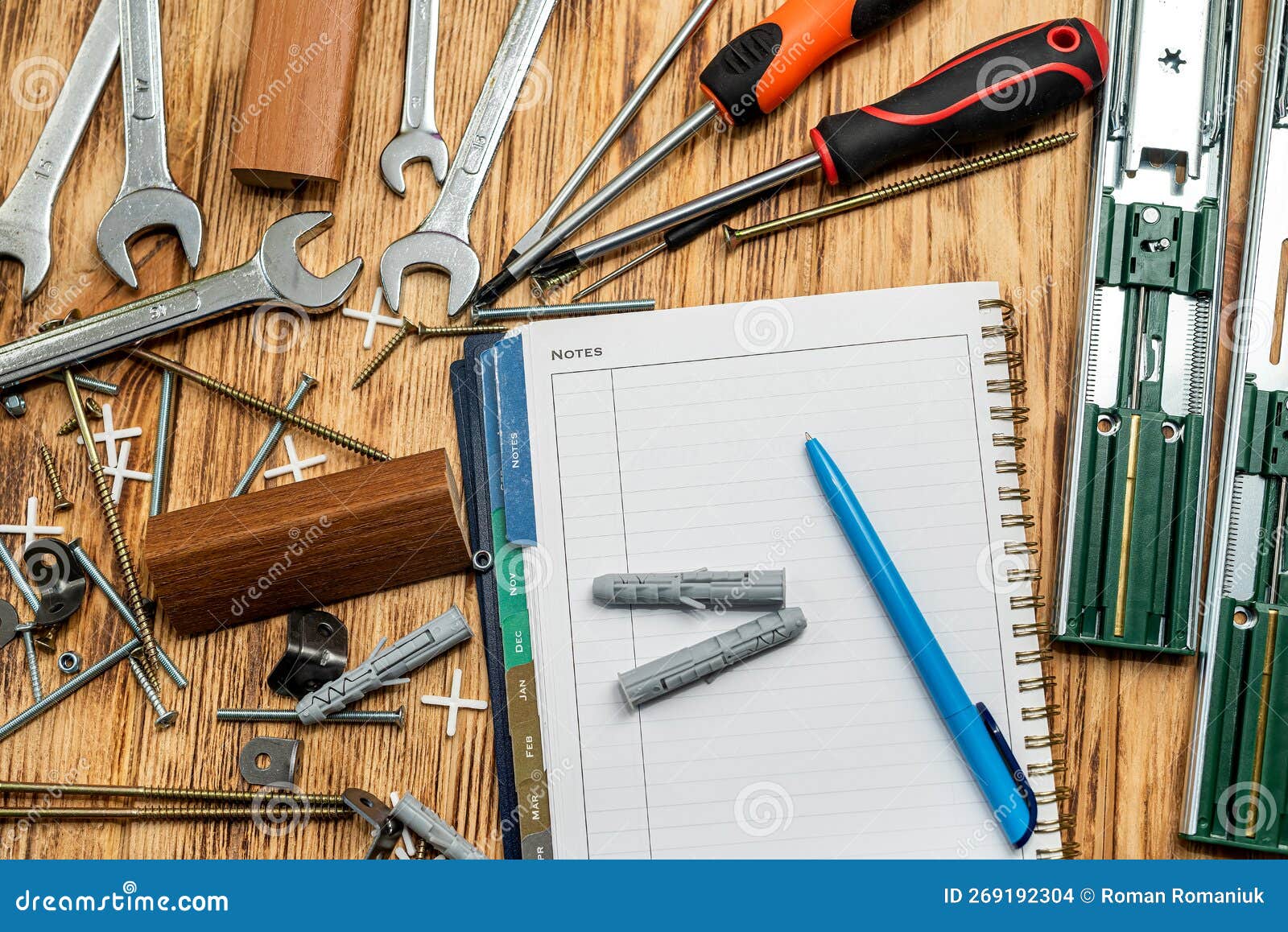 Dowel Screws and Keys are Scattered on the Table Next To a Folder and a ...