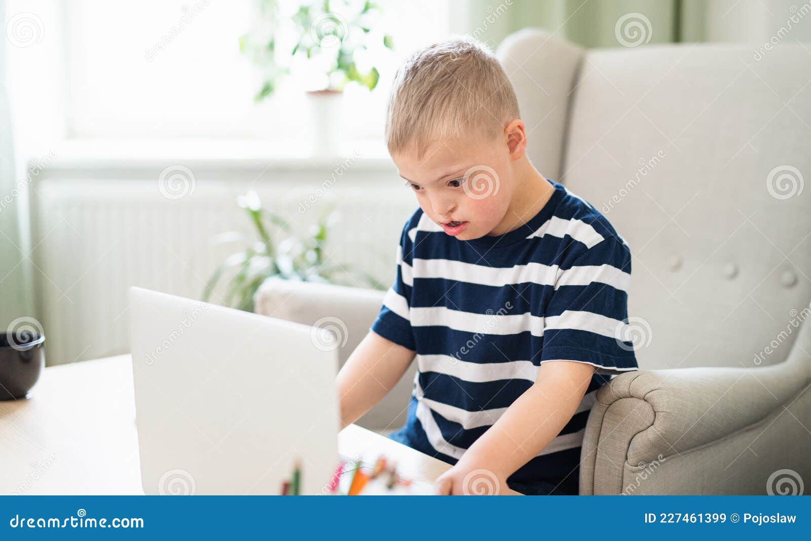 Down Syndrome Boy Indoors at Home, Using Laptop. Stock Image - Image of ...
