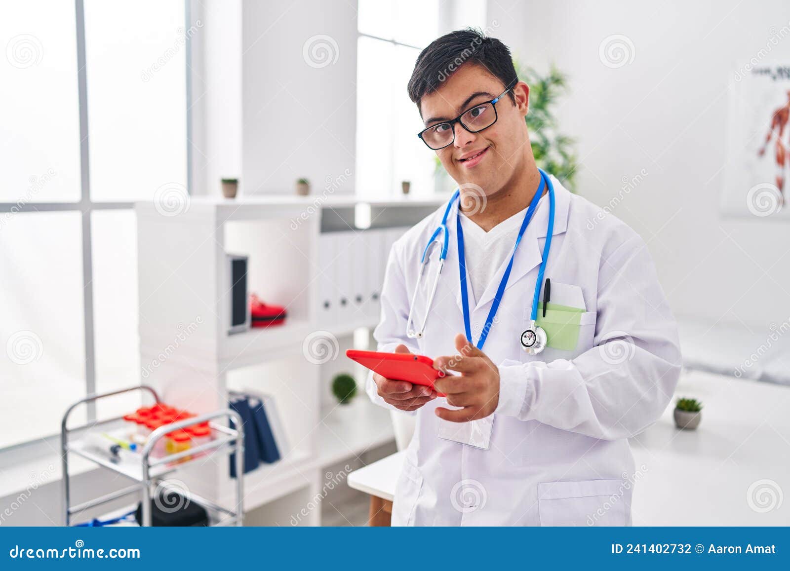 Down Syndrome Man Wearing Doctor Uniform Using Touchpad at Clinic Stock ...