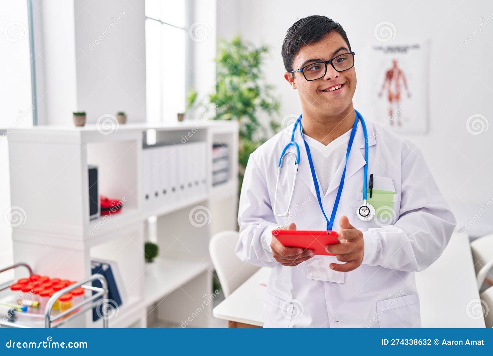 Down Syndrome Man Wearing Doctor Uniform Using Touchpad at Clinic Stock ...
