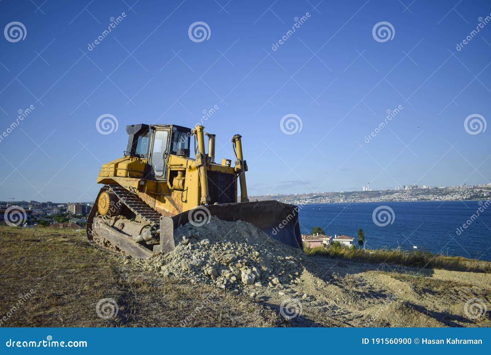 Dozer running by the sea stock photo. Image of beachn - 191560900