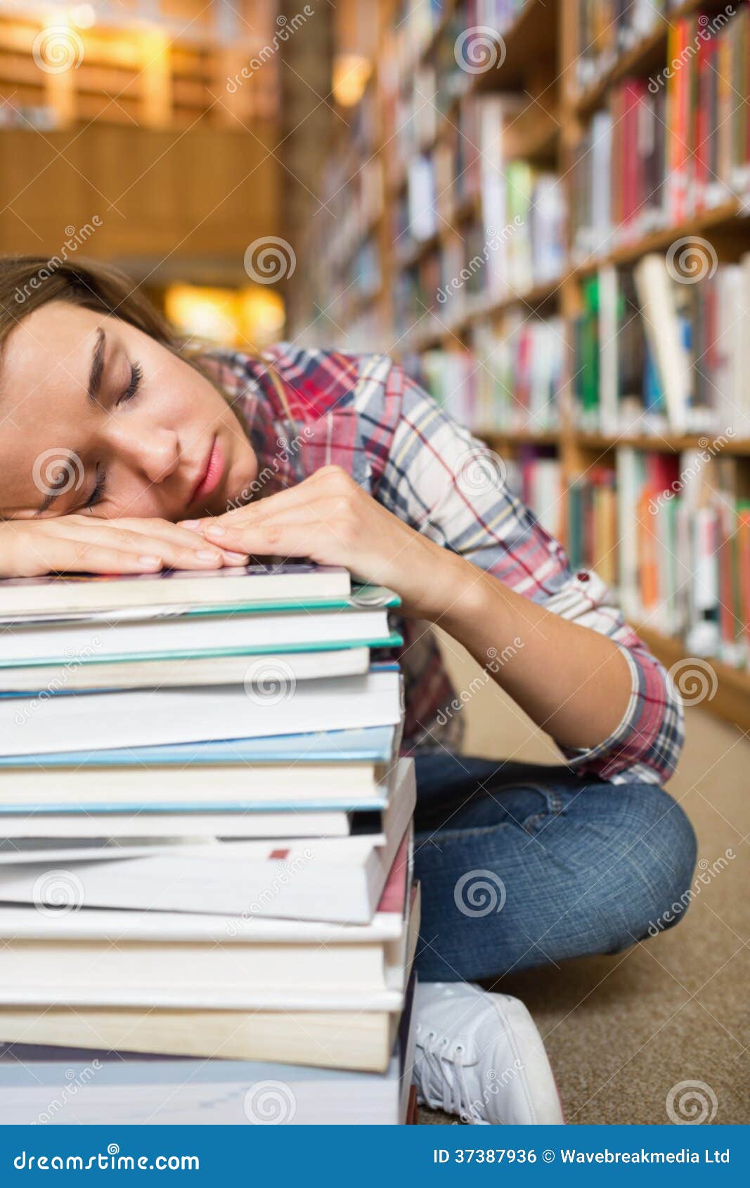 Dozing Young Student Sitting On Library Floor Leaning On Pile Of Books ...