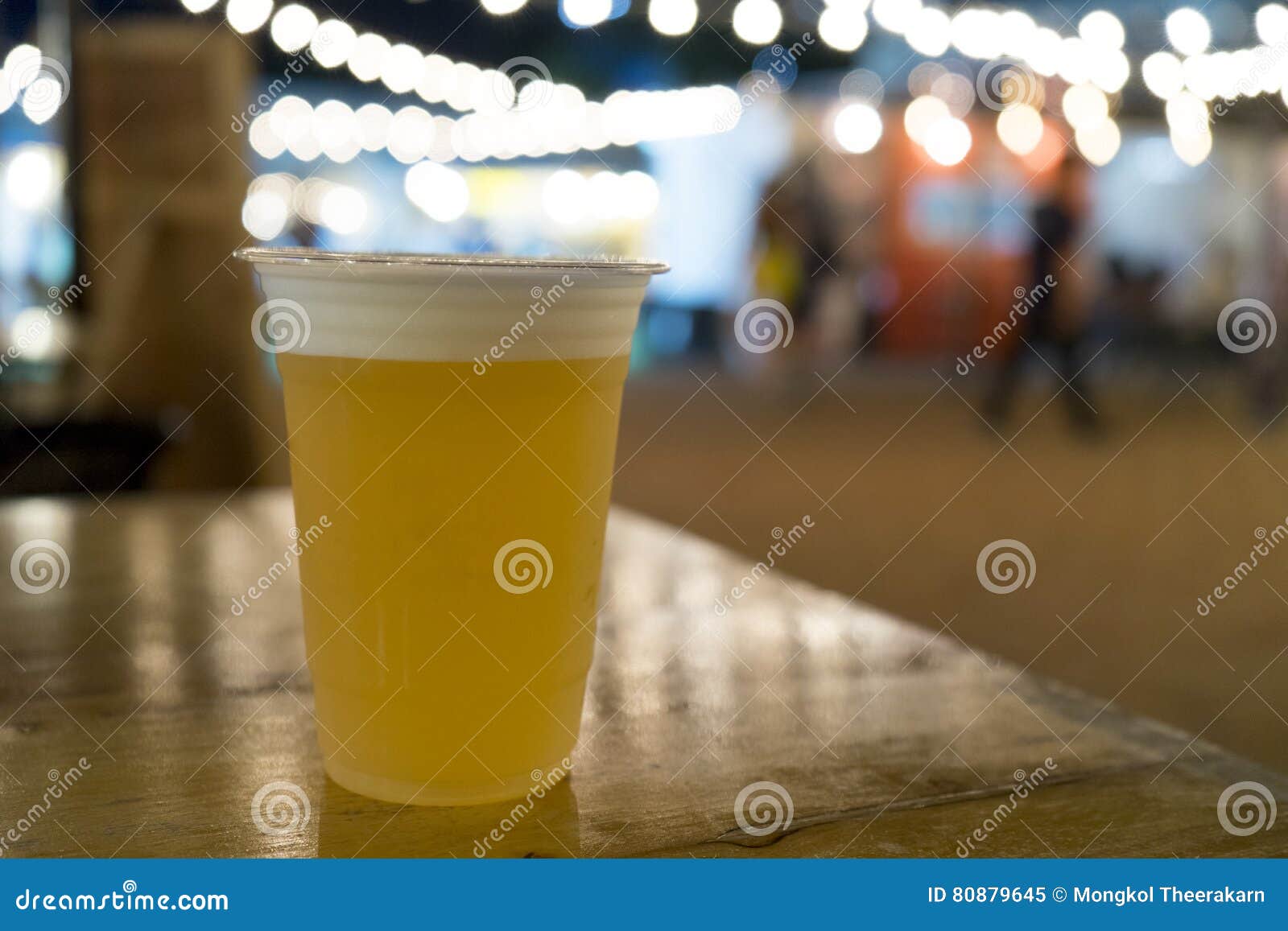 Draft Beer in Plastic Cup on Wooden Table at Festival with Bokeh Light ...