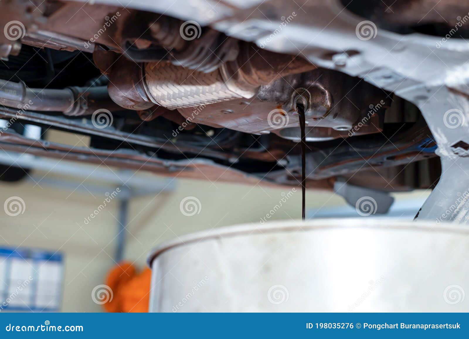 Drain the Old Automotive Engine Oil from Car Engine through the Drain ...