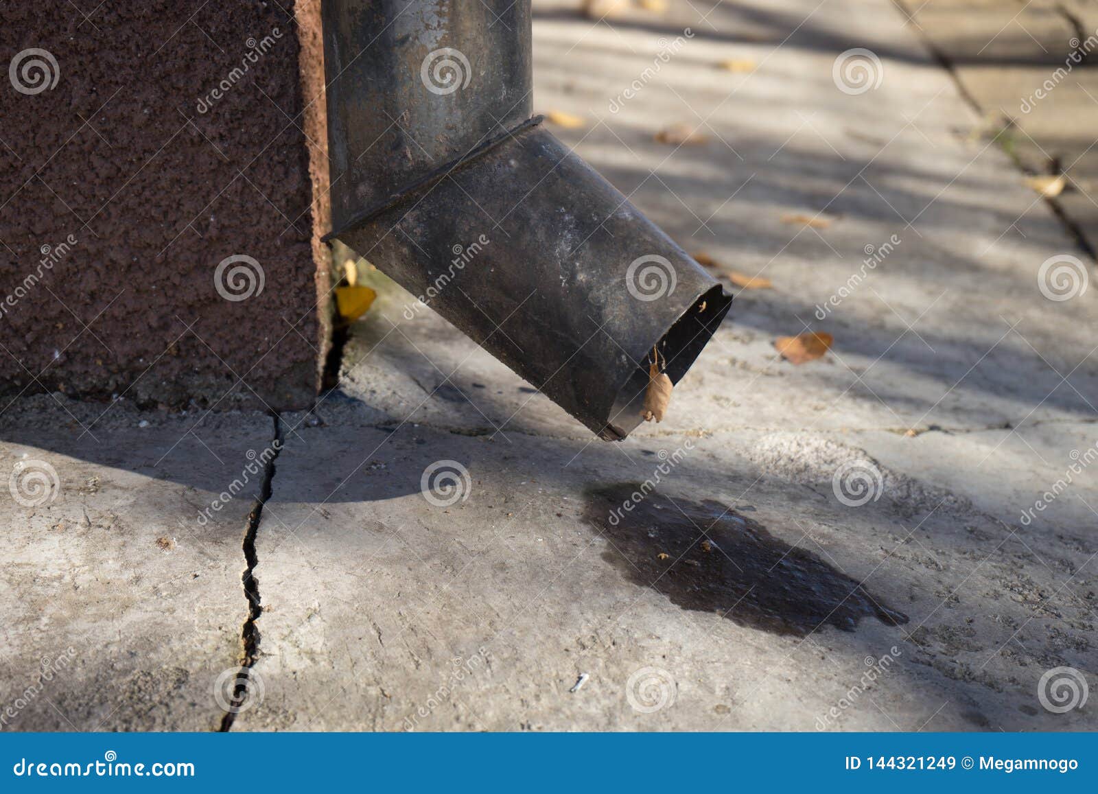 Drain Pipe on the Corner of the House with a Small Puddle Stock Image ...
