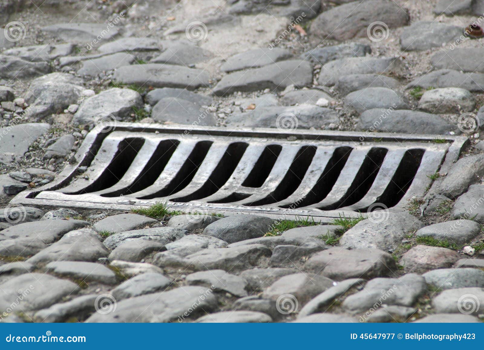 Drain in a cobbled street stock image. Image of cobbled - 45647977