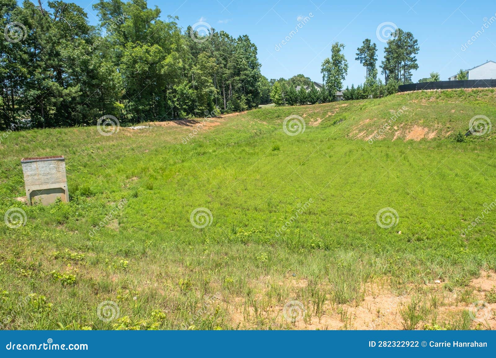 Drainage Ditch Lined with Grass and Weeds Behind a Subdivision Stock ...