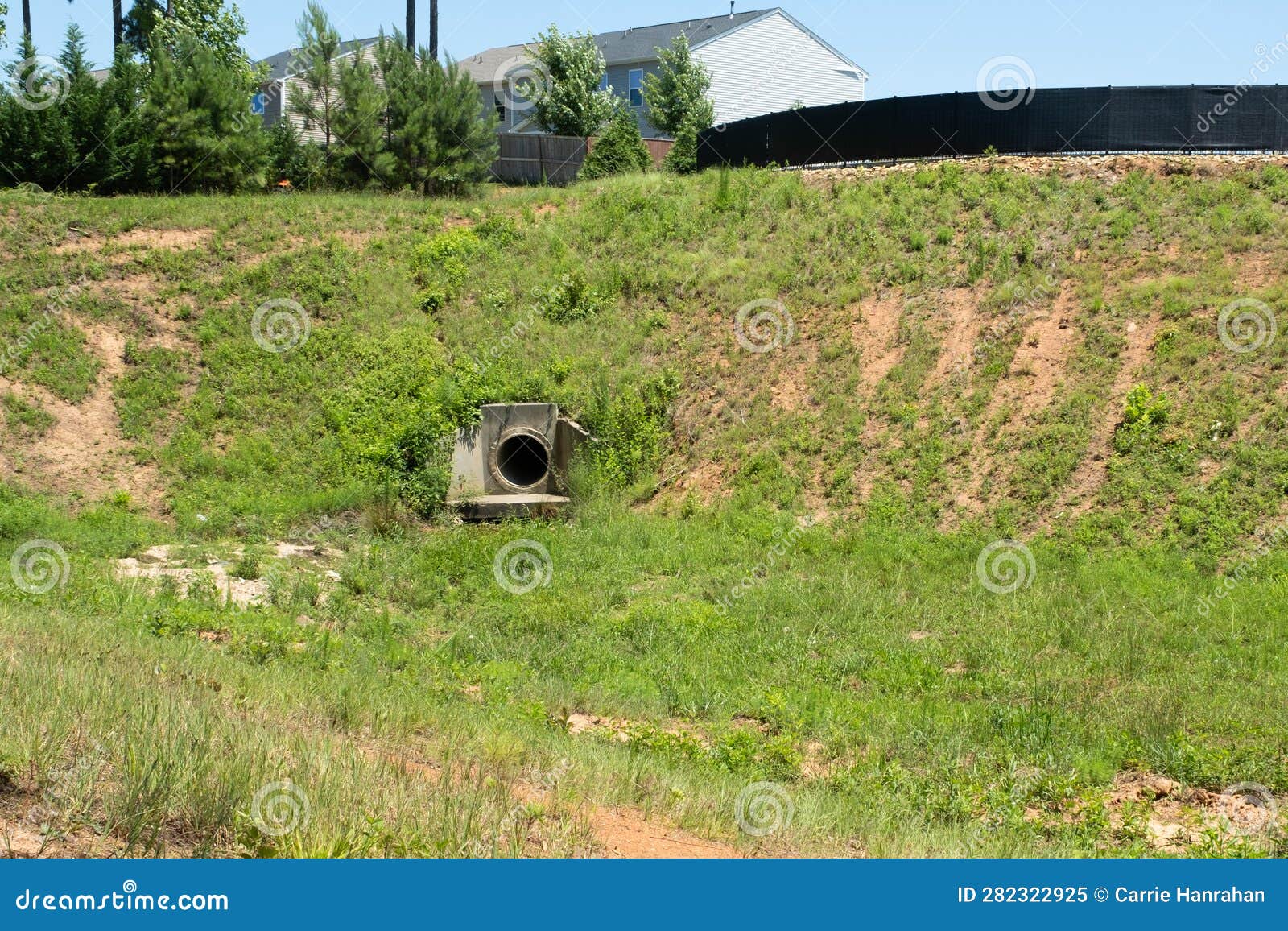 Drainage Ditch Lined with Grass and Weeds Behind a Subdivision Stock ...