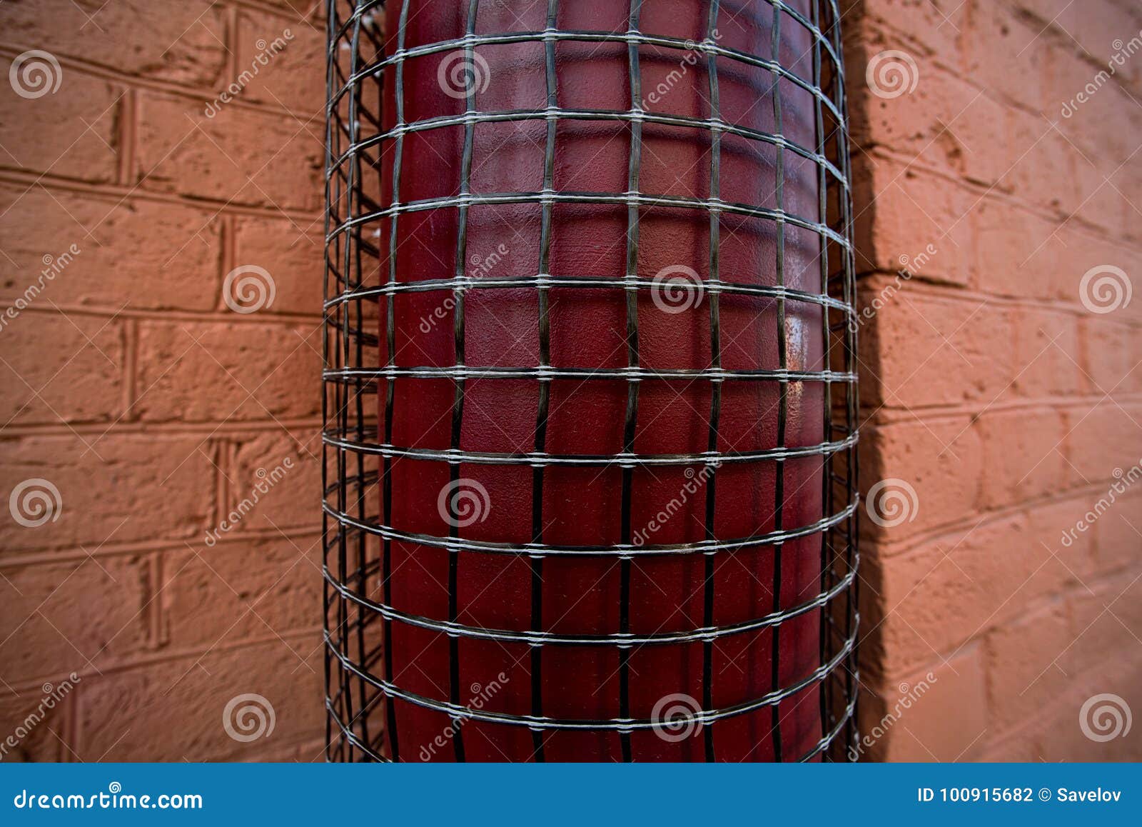 Drainpipe in a Protective Grid on a Brick Wall Stock Photo - Image of ...