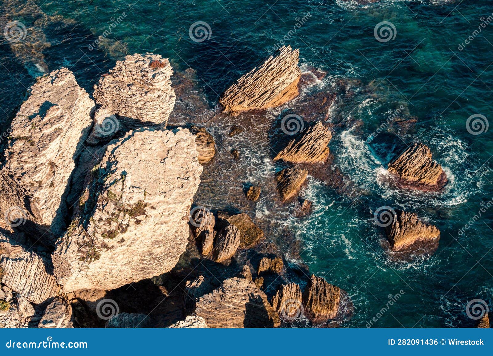 Dramatic Cliff with the Backdrop of a Beautiful Ocean Stock Photo ...