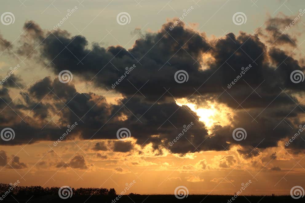 Dramatic Clouds with Sun Behind at Sunset Stock Image - Image of ...
