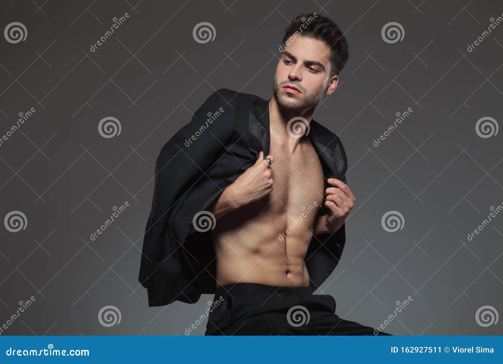 Dramatic Cool Guy Pulling Jacket on Shoulders and Looking To Side Stock ...