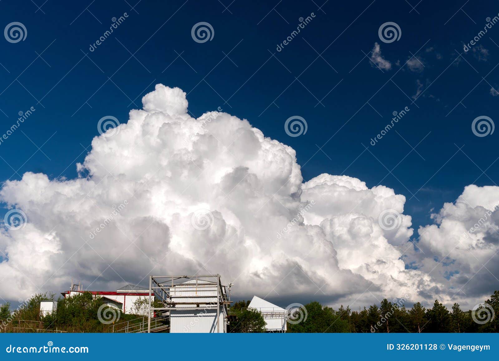 Dramatic Cumulus Clouds Over Rural Area with Trees and Structures Stock ...