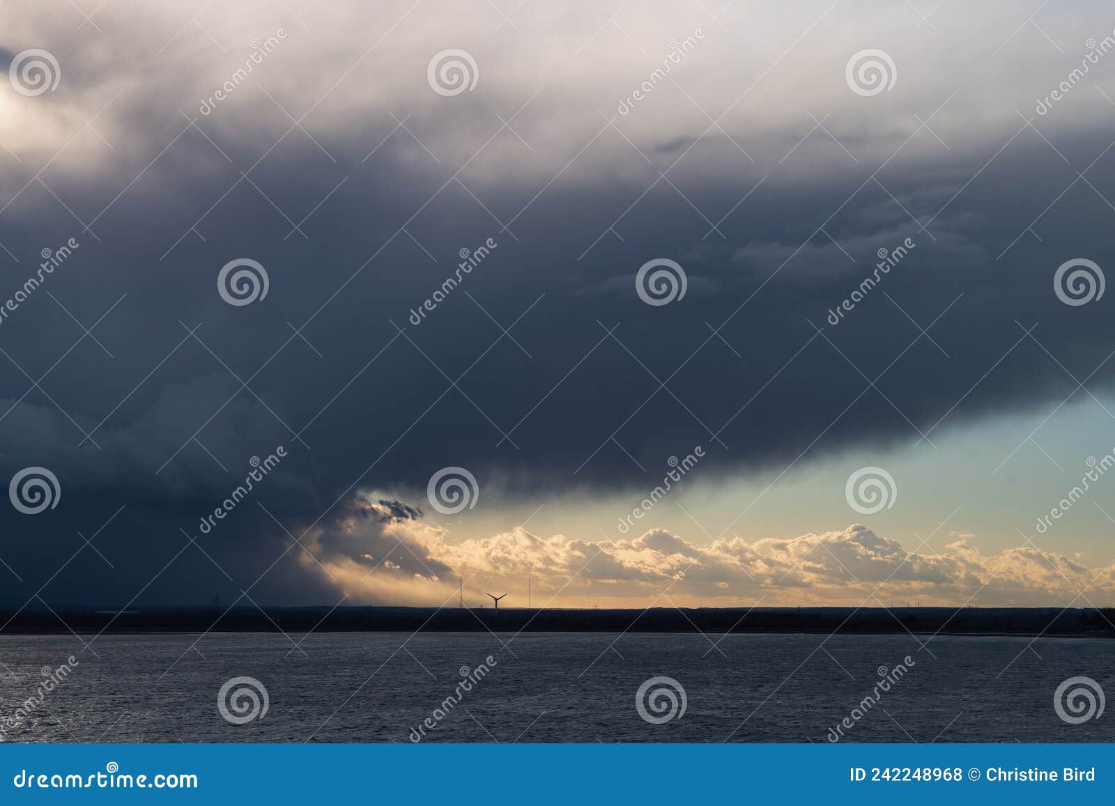 A Dramatic Image of a Rain Cloud on the Horizon Above the Sea and a ...