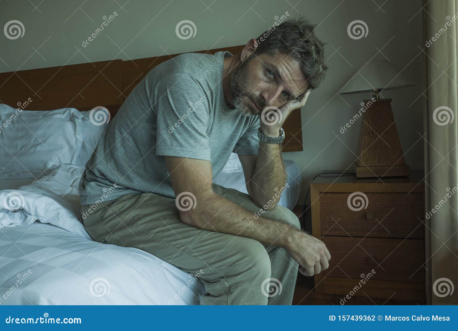 Dramatic Lifestyle Portrait of Handsome Guy Sitting on Bed Feeling Sad ...