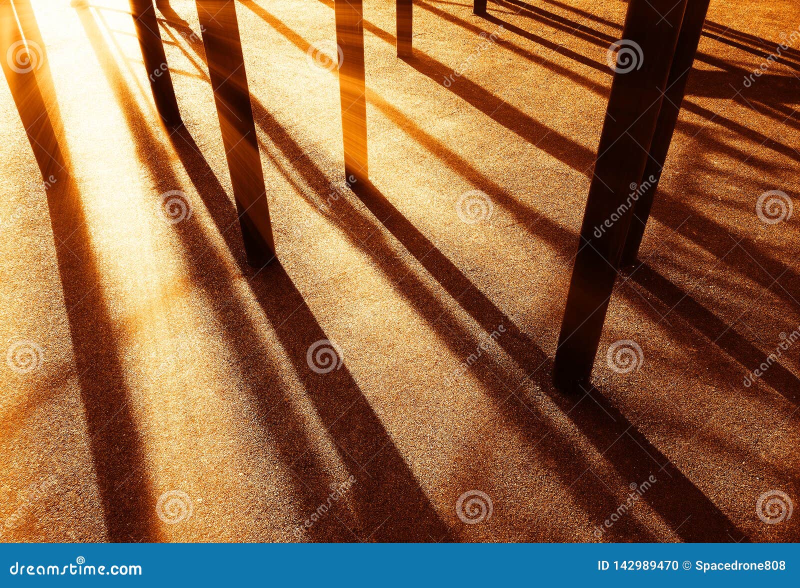 Dramatic Light Rays through Vertical Poles Background Stock Photo ...