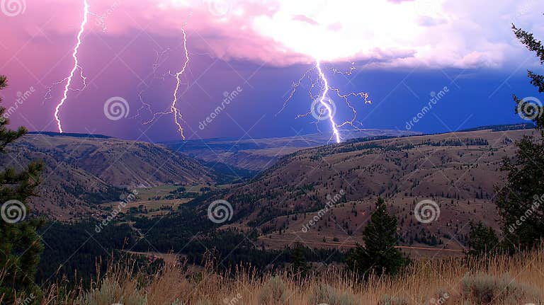Dramatic Lightning Storm Over a Valley Landscape at Sunset Stock Photo ...