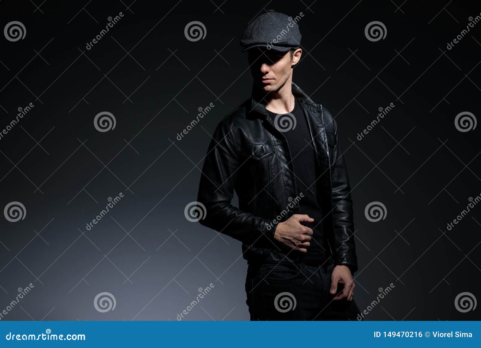 Dramatic Looking Guy Pulling His Black Leather Jacket Stock Photo ...