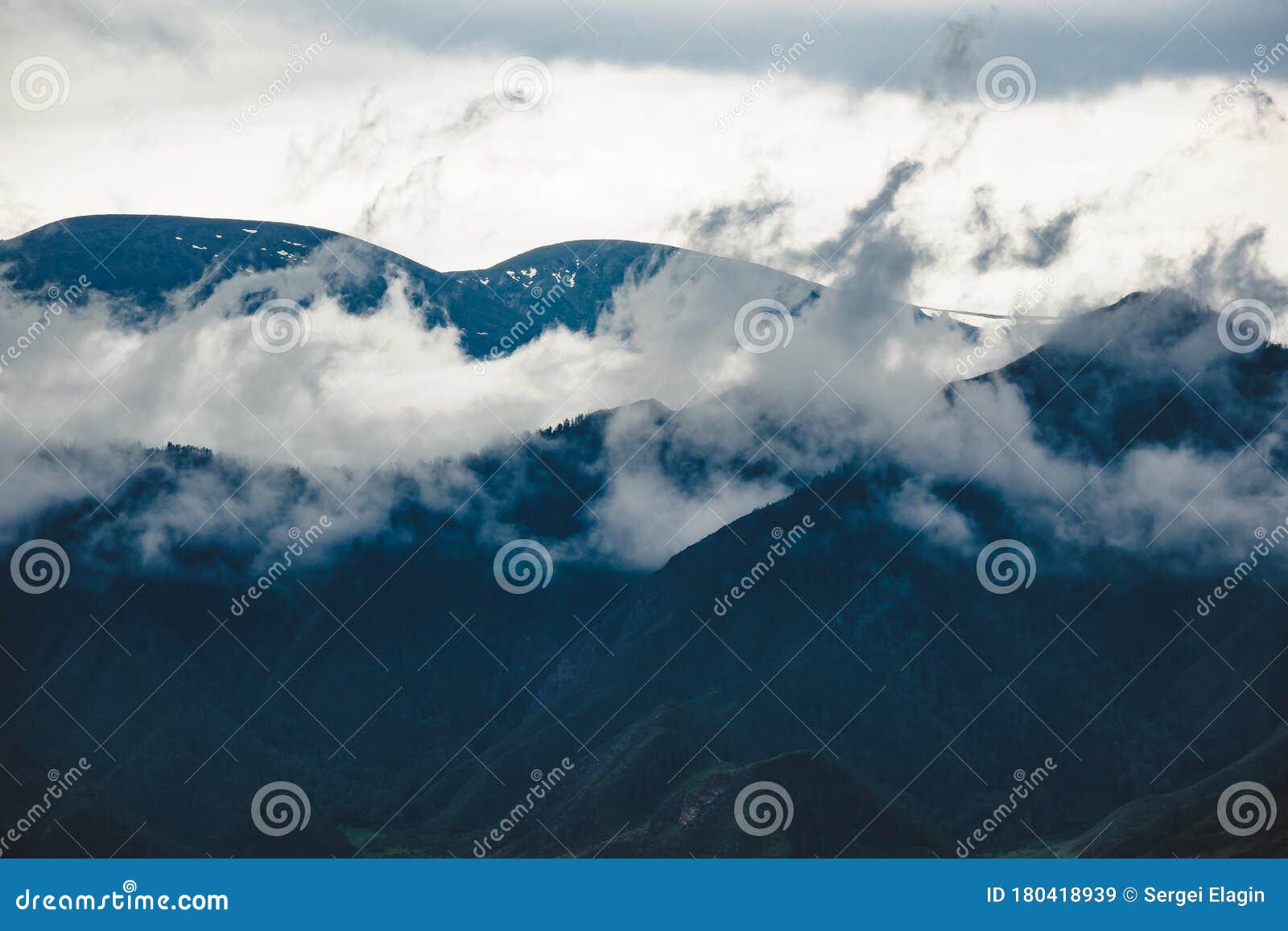 A Dramatic-looking Mountain Range in the Clouds in the Altai Krai Stock ...