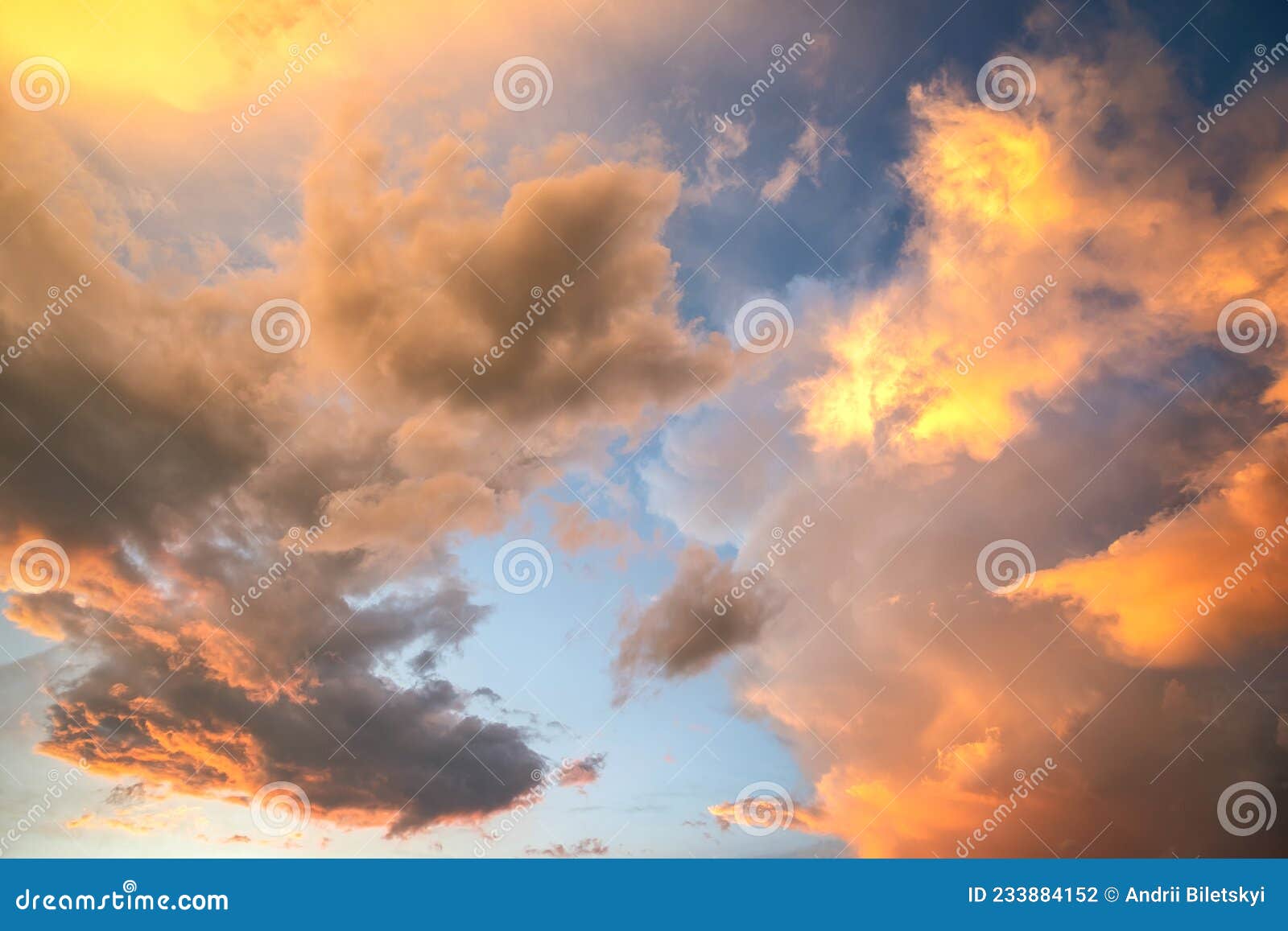 Dramatic Moody Sunset Landscape with Puffy Clouds Lit by Yellow Setting ...