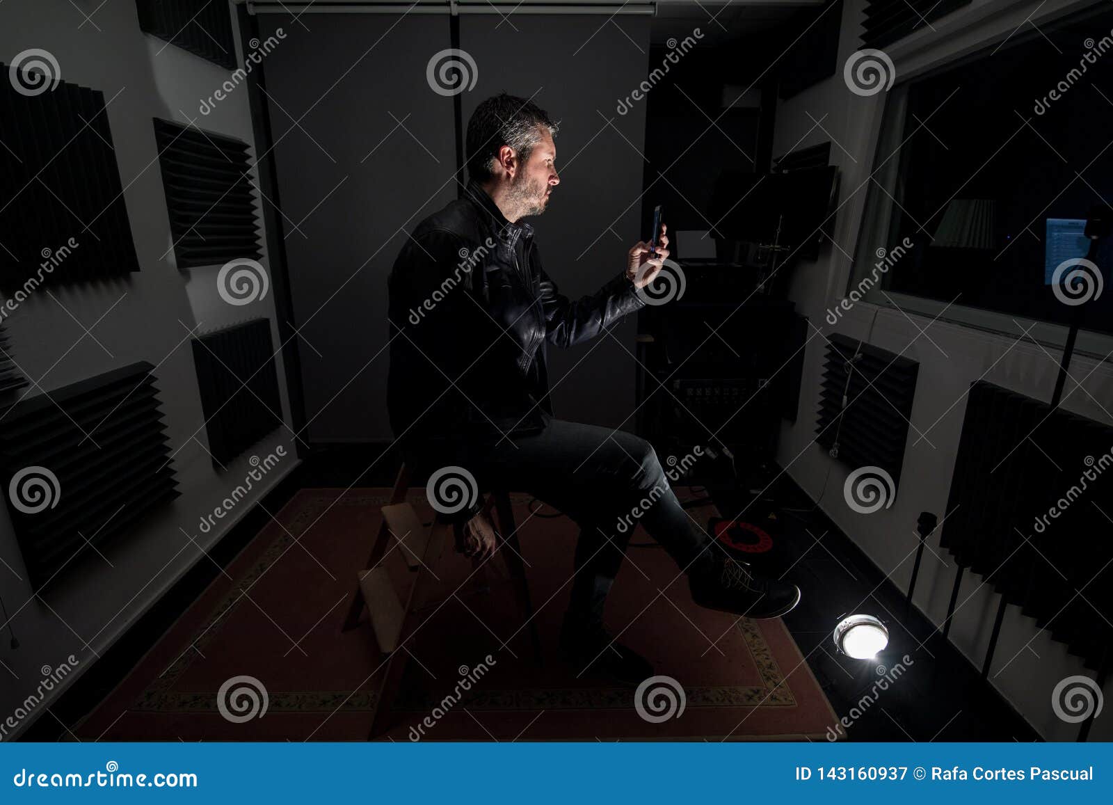 Dramatic Portrait of a Guy Looking at a Cell Phone. Stock Image - Image ...