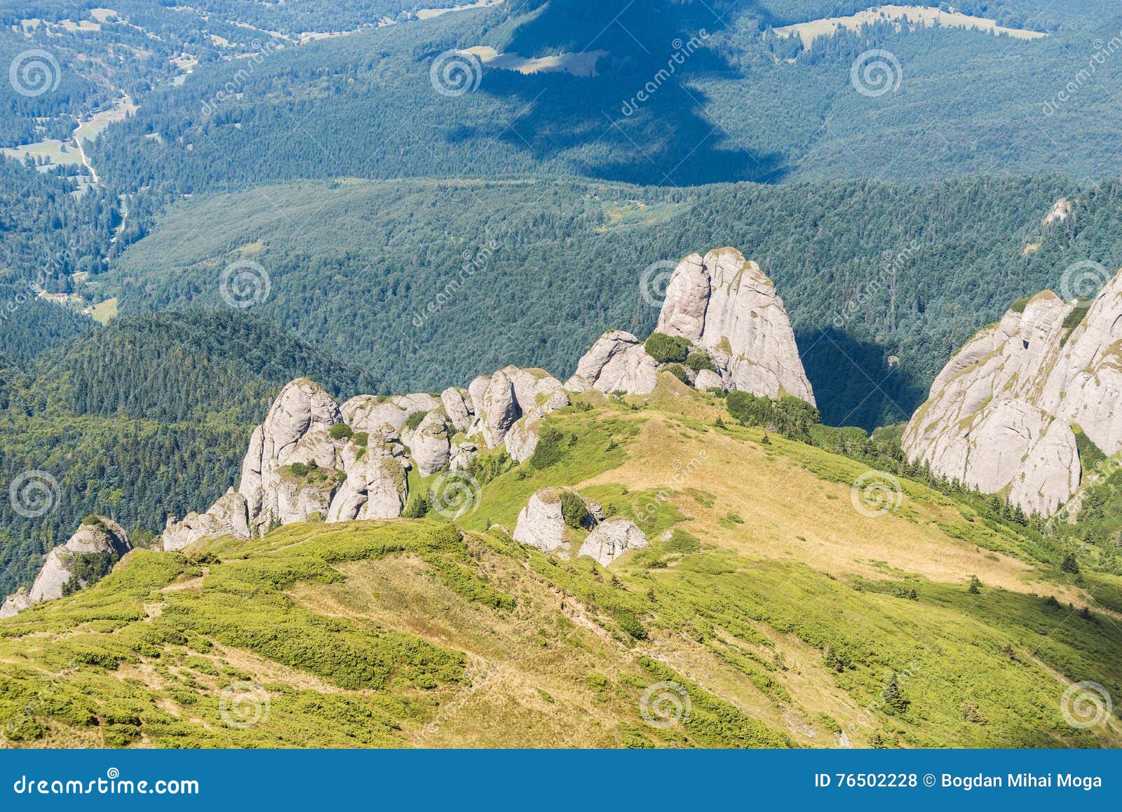 Dramatic Rocky Peaks Set Against Forested Mountain Range Stock Photo ...