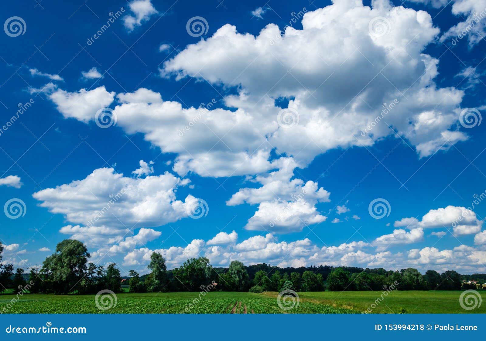 Dramatic Scenic Clouds in an Intense Blue Sky Over Green Landscape ...