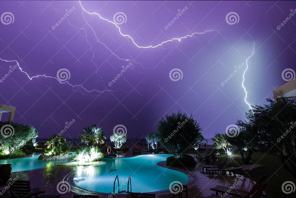 Dramatic Shot of Lightning Over the Pool Illuminated by Lights Stock ...