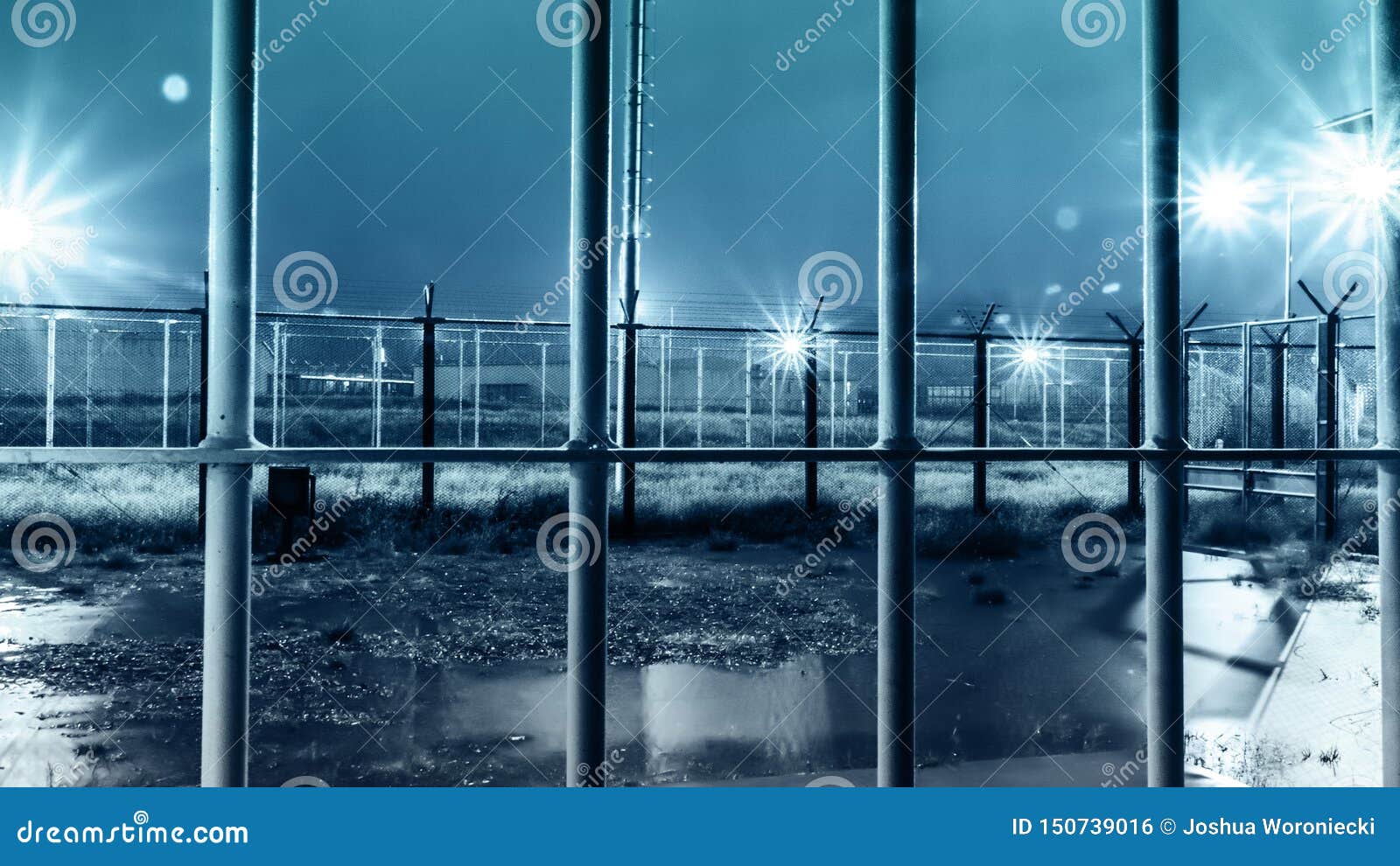 Dramatic Shot of High Security Prison Facility Yard from Inside Iron ...