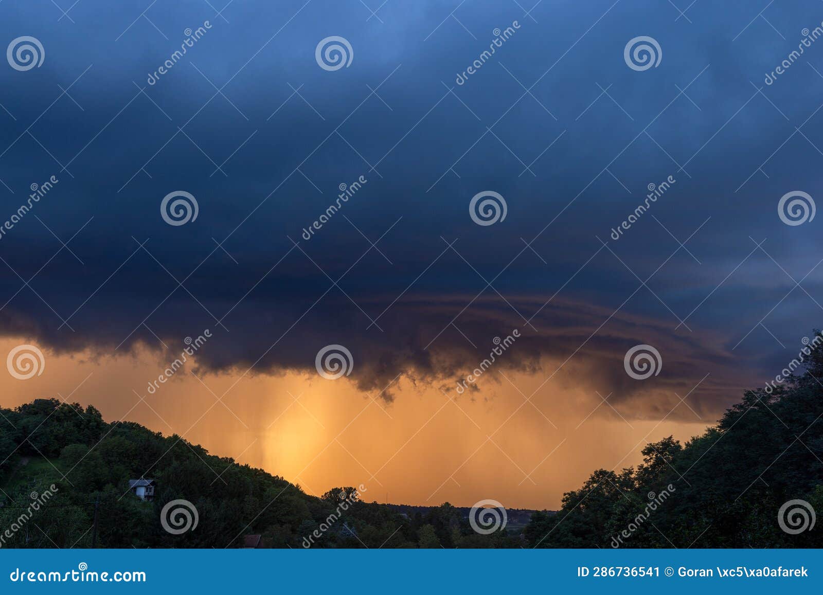 Dramatic Storm Clouds with an Intense Rain Lit by the Setting Sun Stock ...